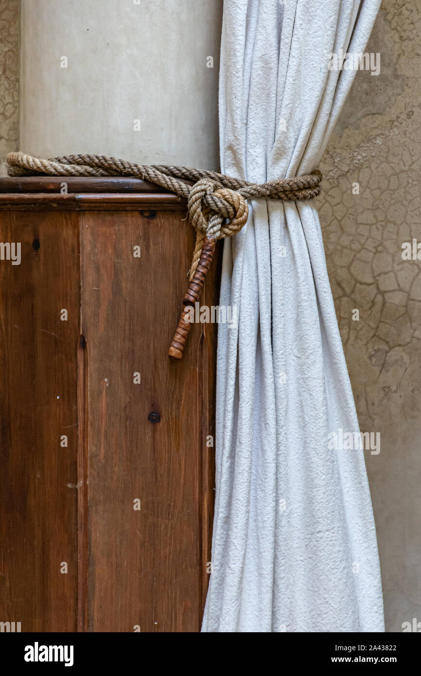 White curtain tied to a column with a rope Stock Photo - Alamy