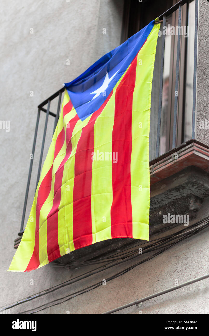 Flag of Catalonia on the balcony of a building in Barcelona. Symbol of ...