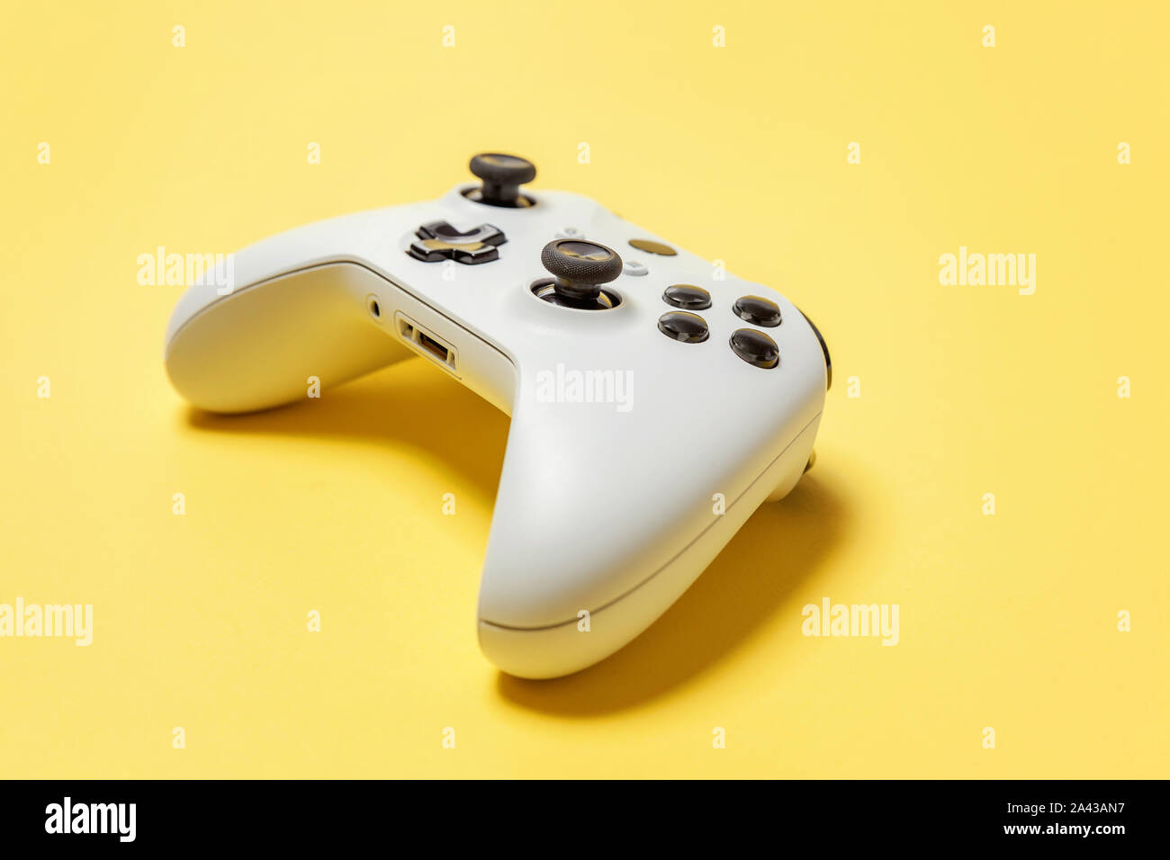 White joystick gamepad, game console on yellow colourful trendy modern ...