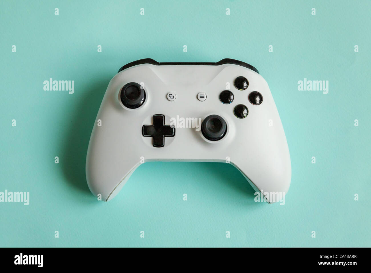 White joystick gamepad, game console isolated on pastel blue colourful ...