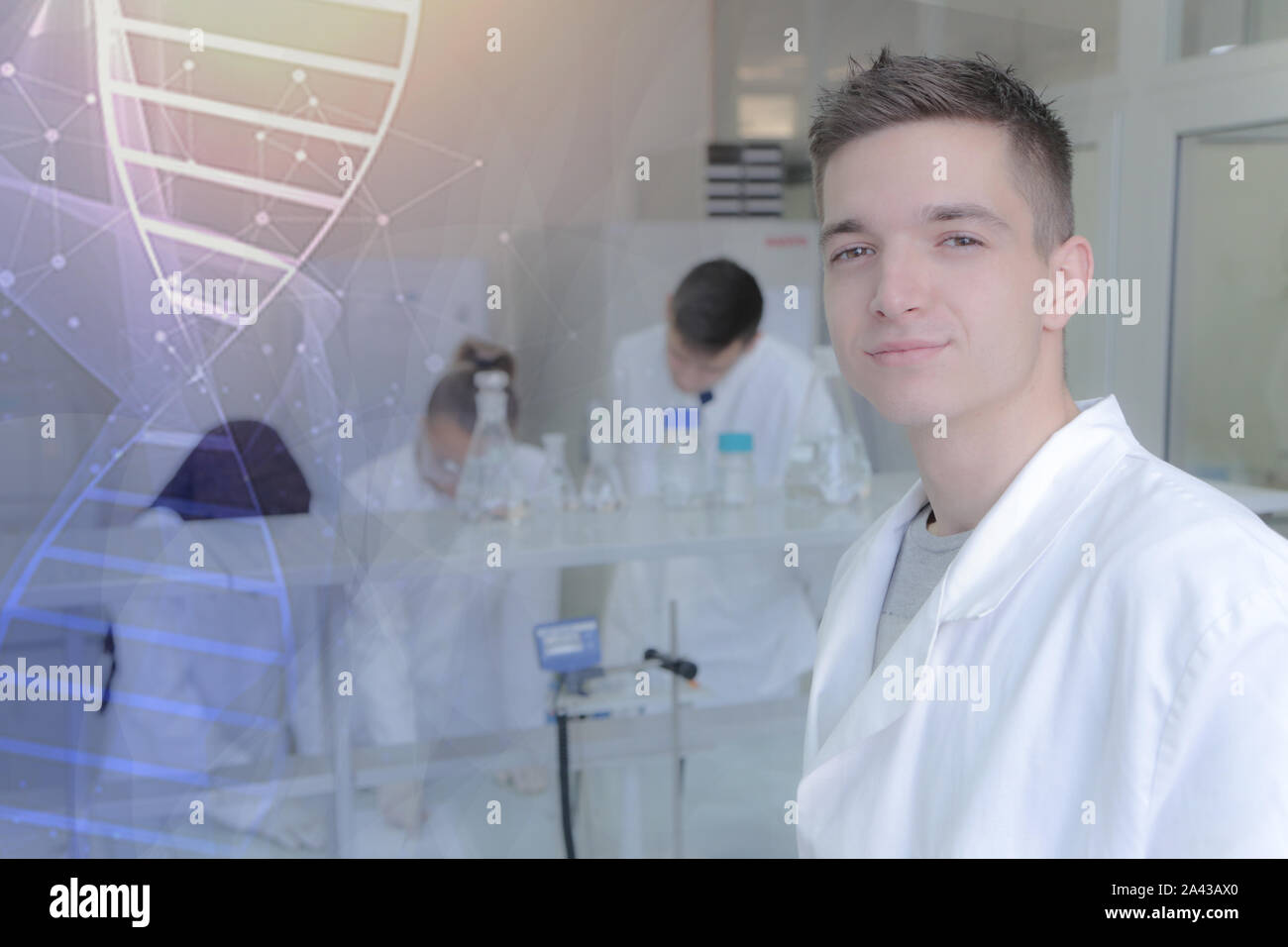 Group of young scientists doing experiments in laboratory with young ...