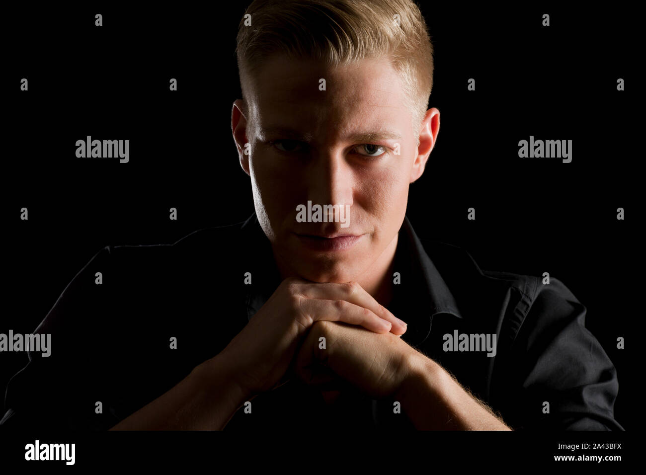 Low key portrait of young likable man Stock Photo - Alamy