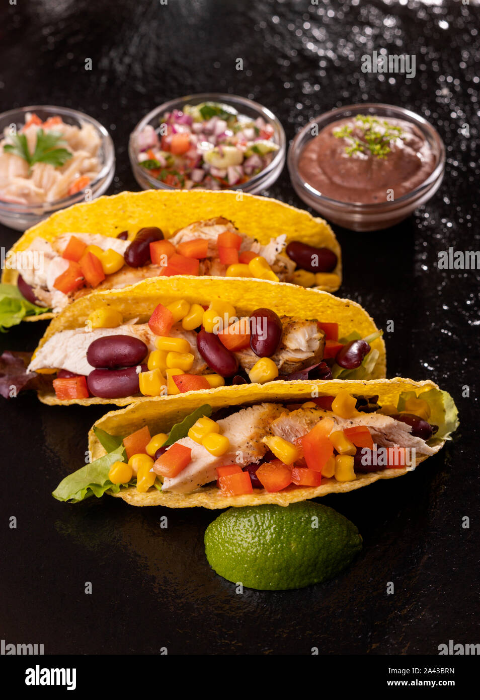 three mexican tacos on slate Stock Photo - Alamy