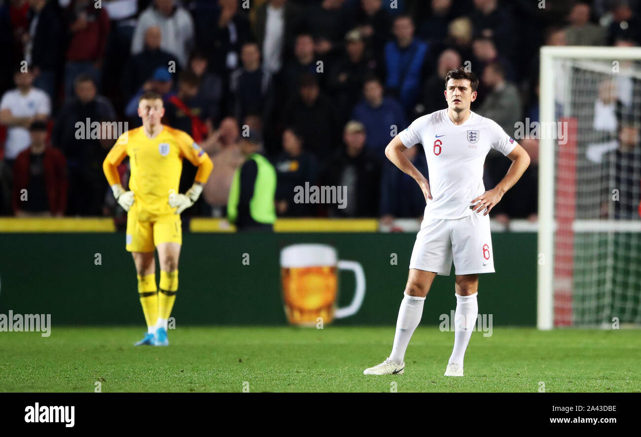 England's Harry Maguire (right) and Jordan Pickford stand dejected ...