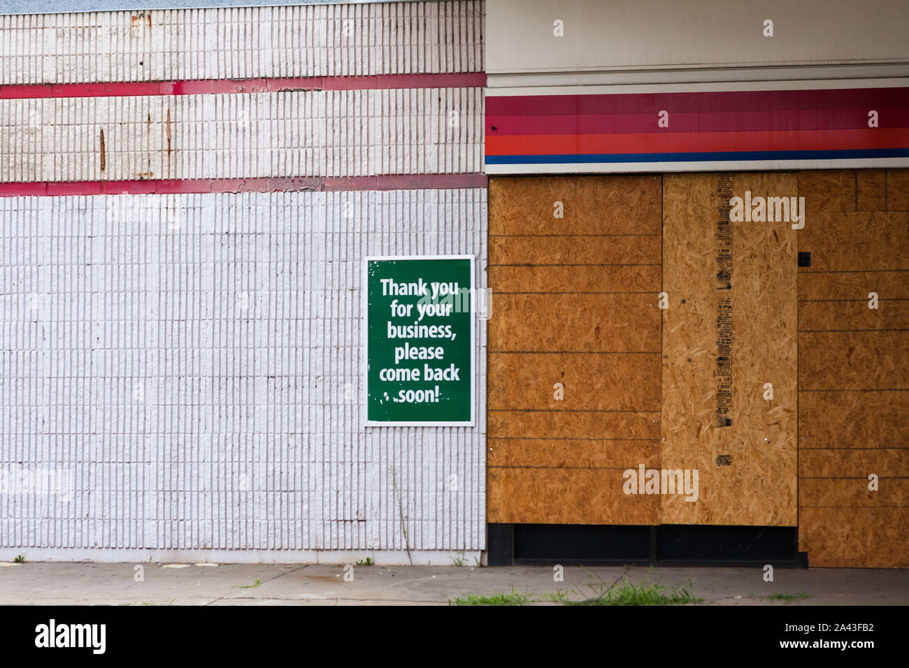 A shuttered business with an ironic sign posted Stock Photo - Alamy