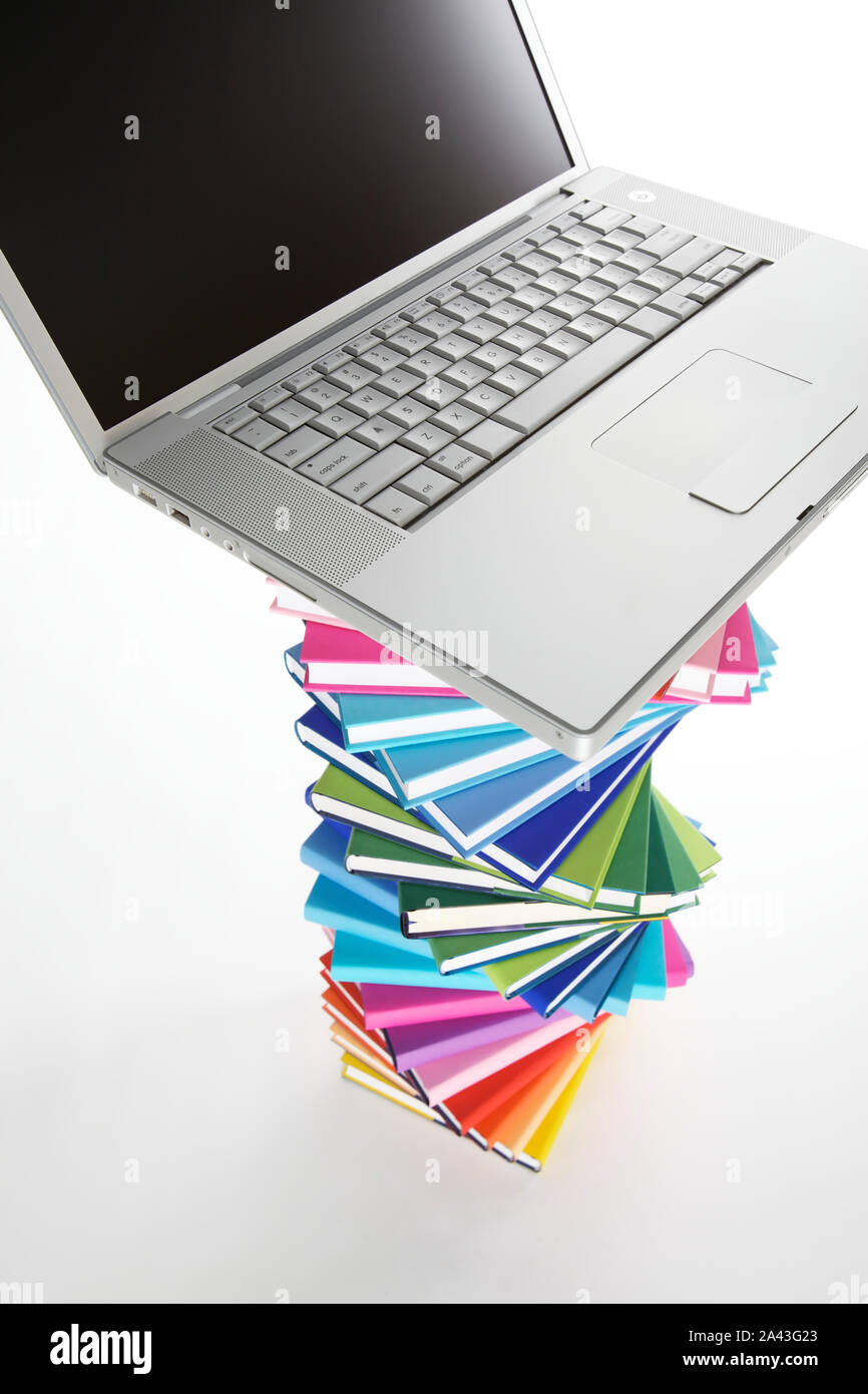 Laptop on spiral book stack, top view Stock Photo - Alamy