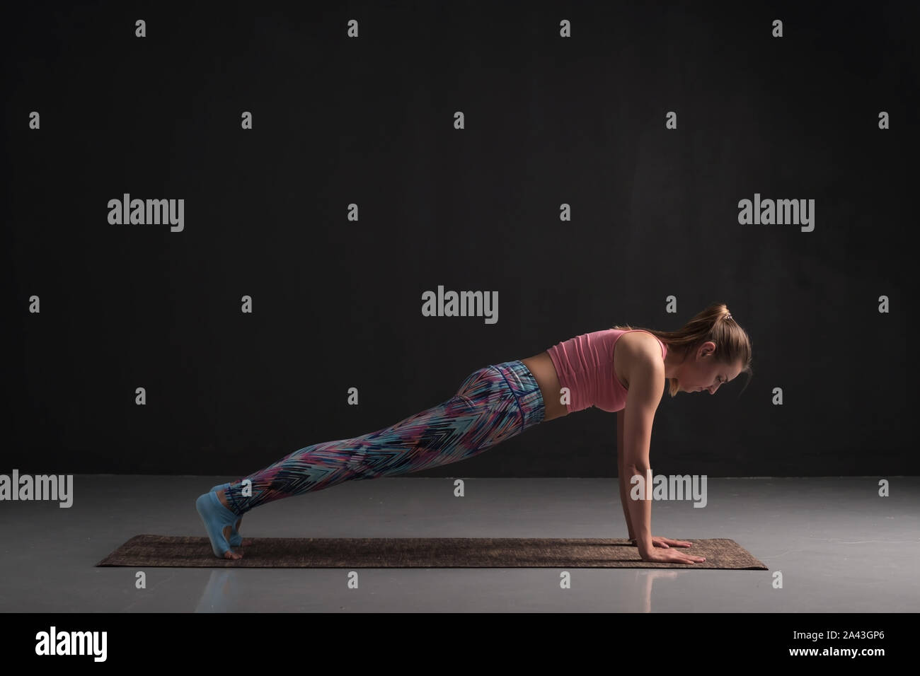 Woman practicing yoga, doing Push ups exercise, phalankasana, Plank ...