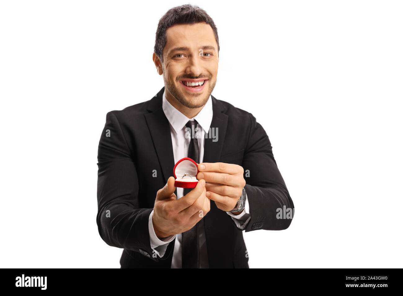 Handsome young happy man proposing with a ring isolated on white ...