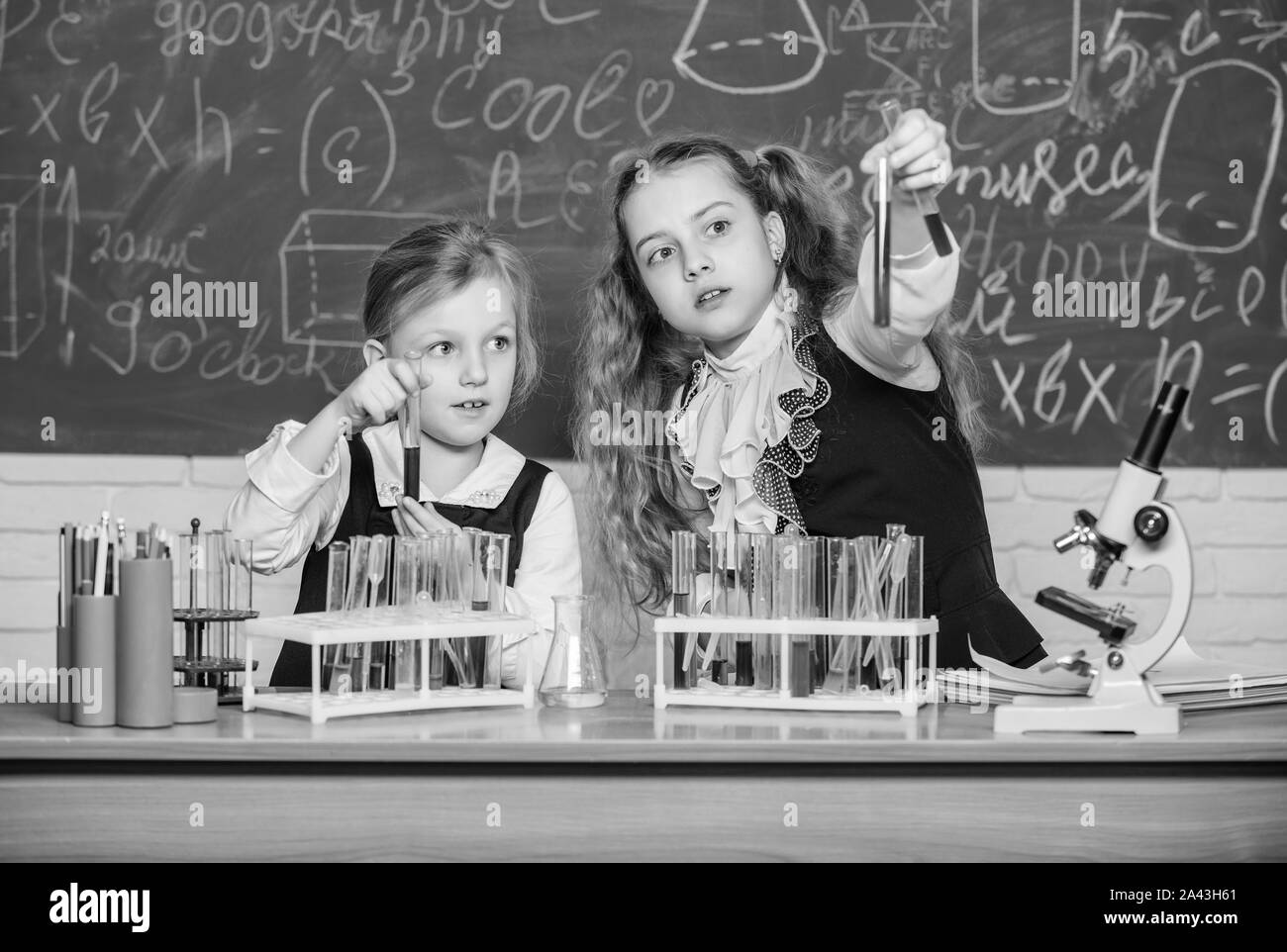 We love science. School children performing experiment in science ...