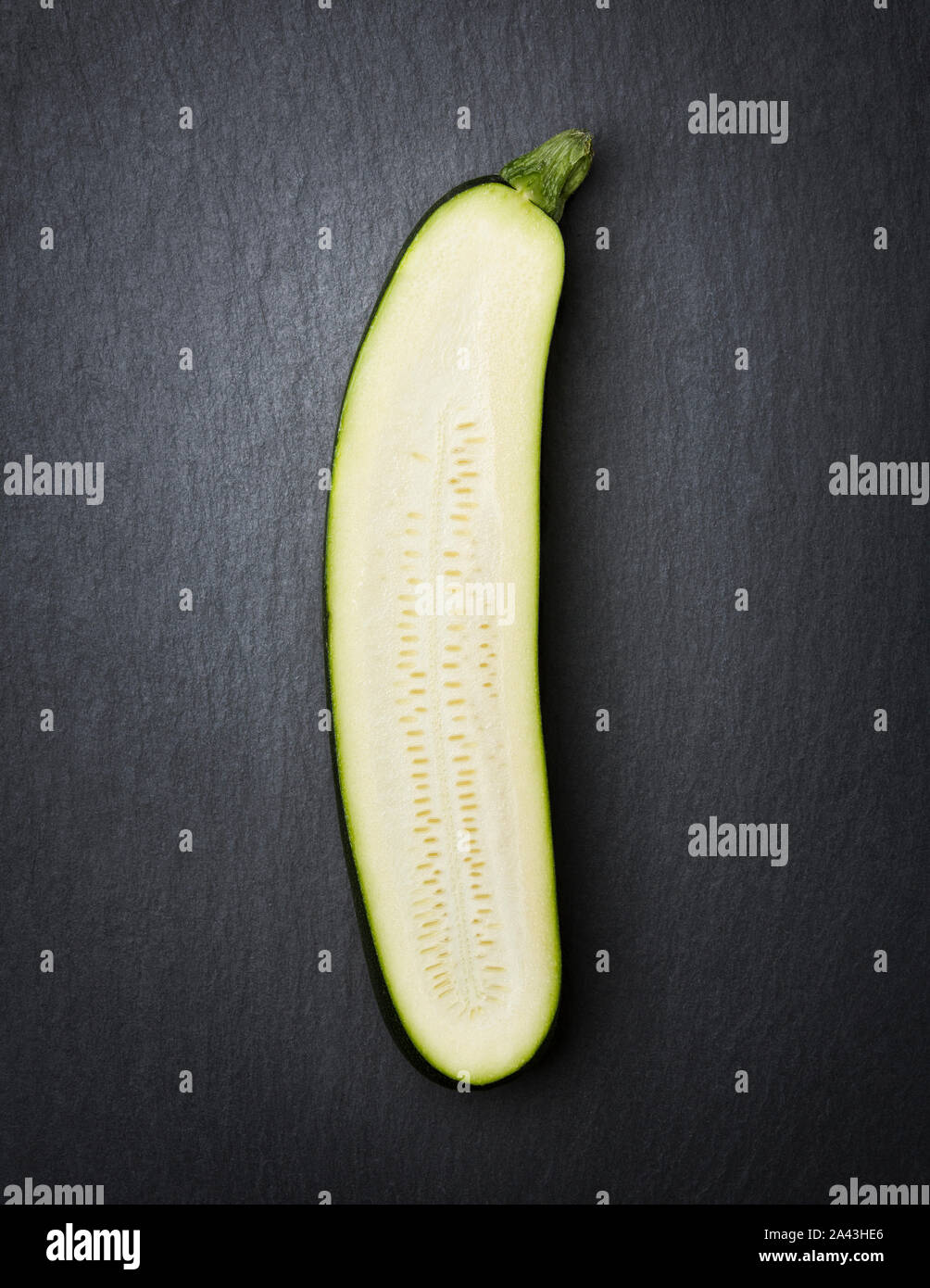 One sliced courgette isolated on stone Stock Photo - Alamy