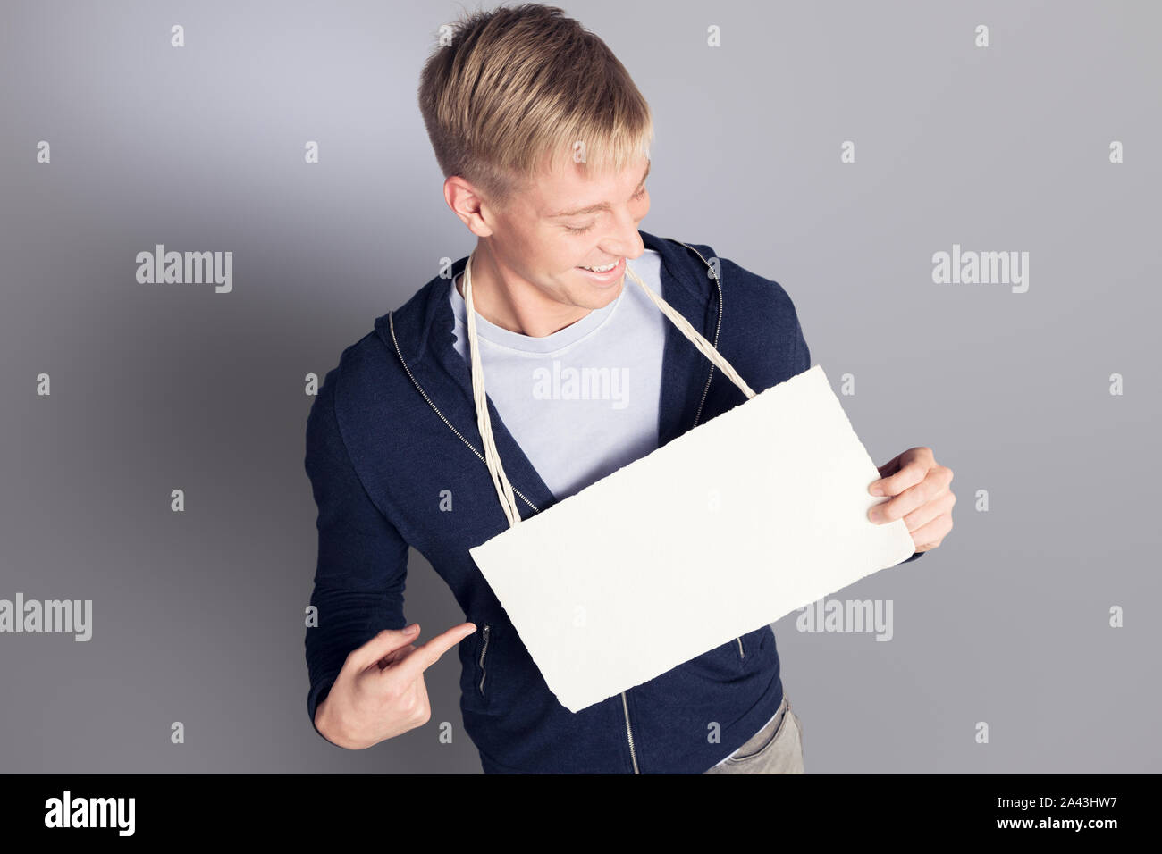 Joyful man pointing finger at blank signboard Stock Photo - Alamy