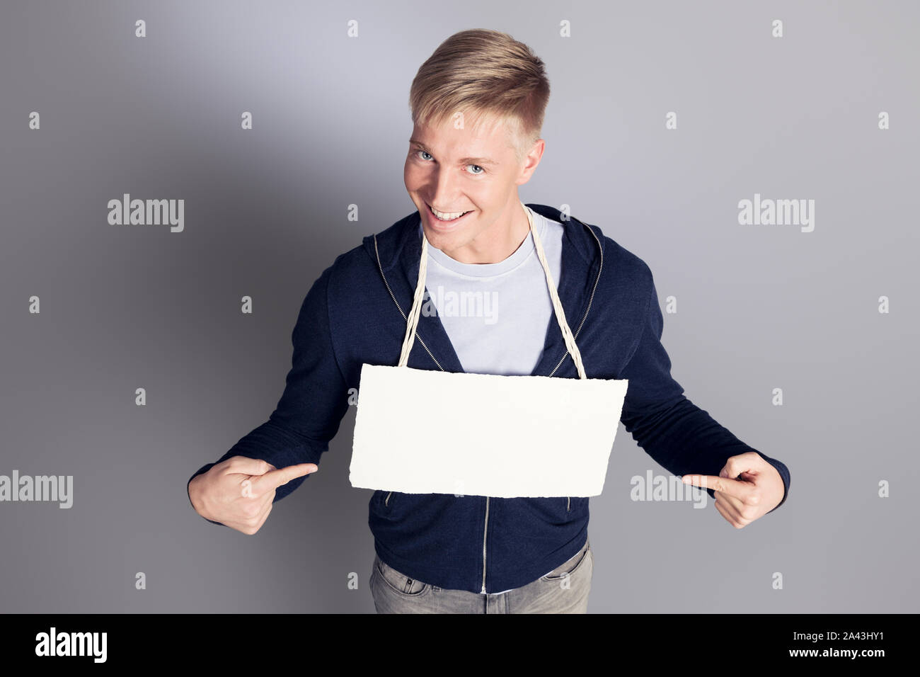 Happy man pointing fingers at white empty signboard Stock Photo - Alamy