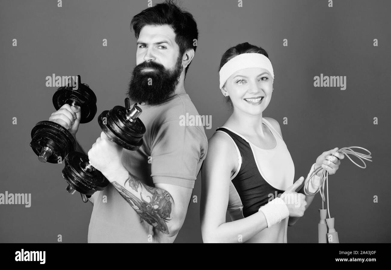 Strong muscles and body. Sport equipment. Sporty couple training with ...