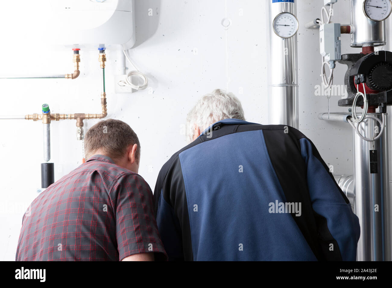 men at work in ac and heating room Stock Photo - Alamy