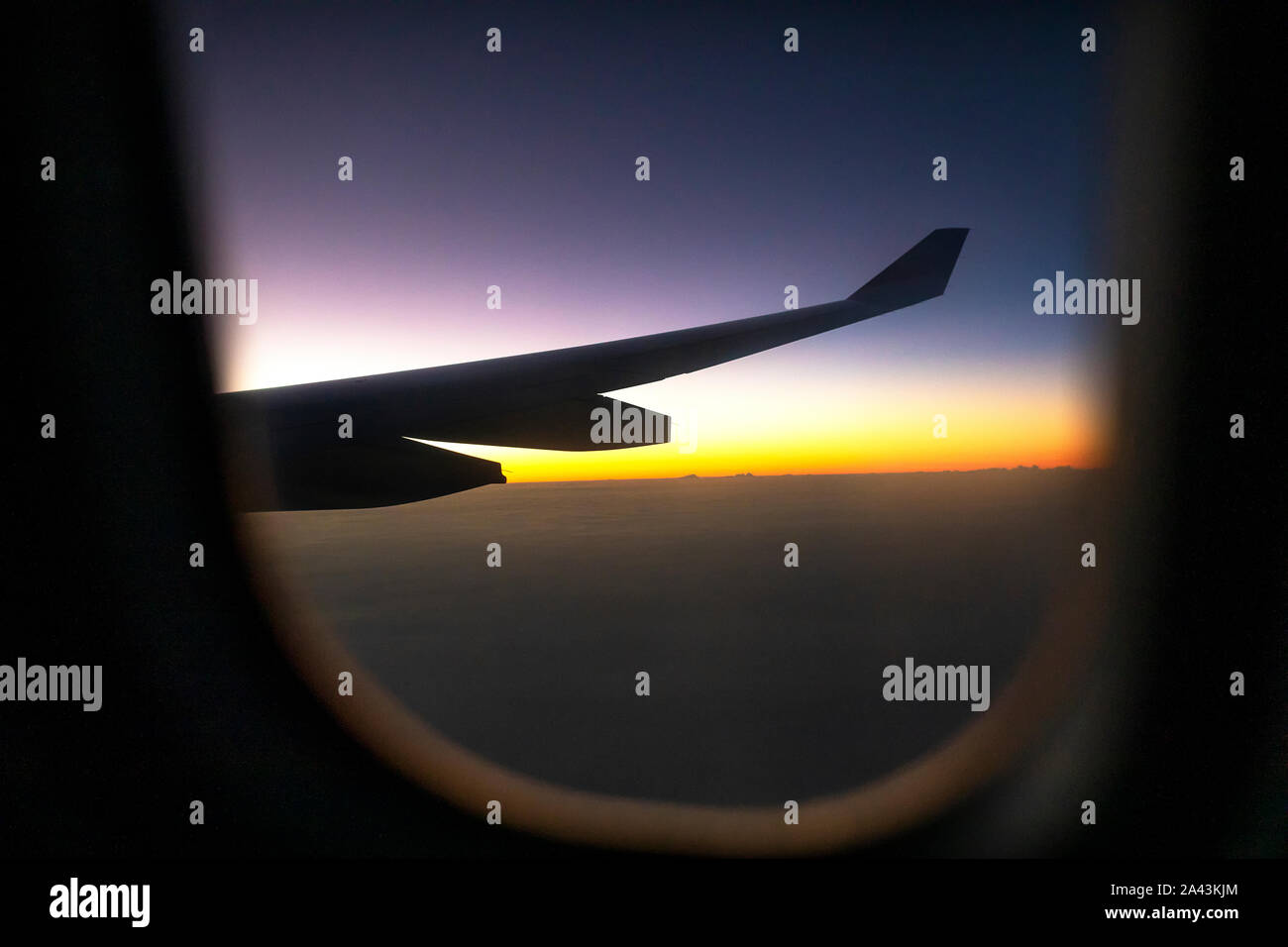 looking through plane window at colorful skyscape Stock Photo - Alamy