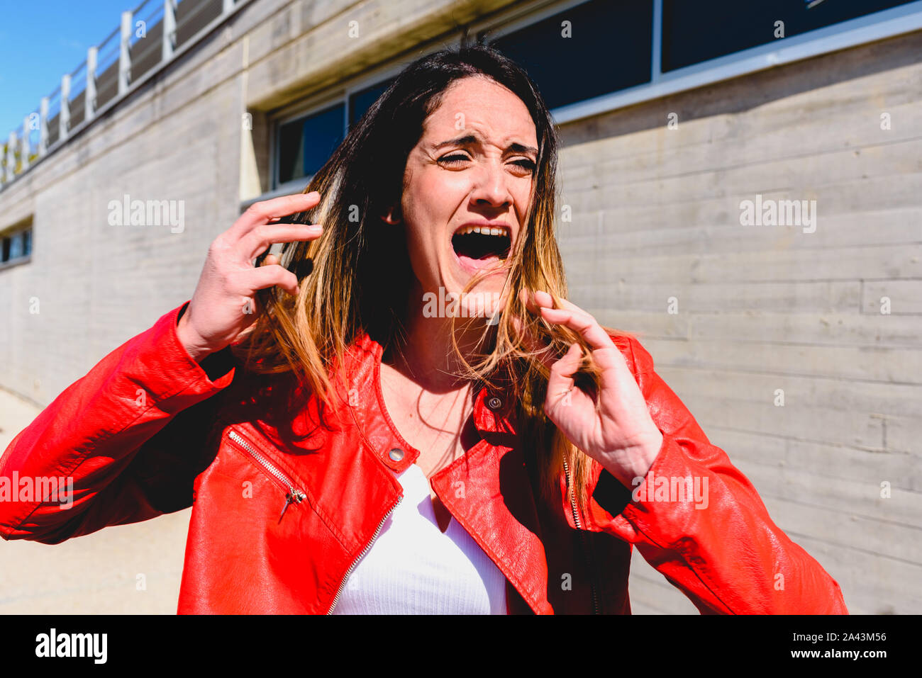 Scared woman is scared and makes a panic face while screaming for help ...