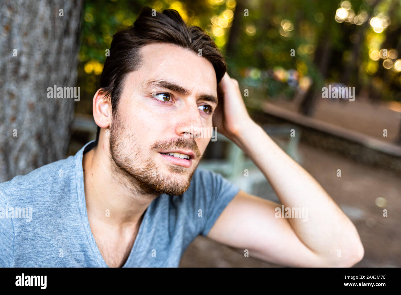 Portrait of a young model man looking up photographed from above with ...