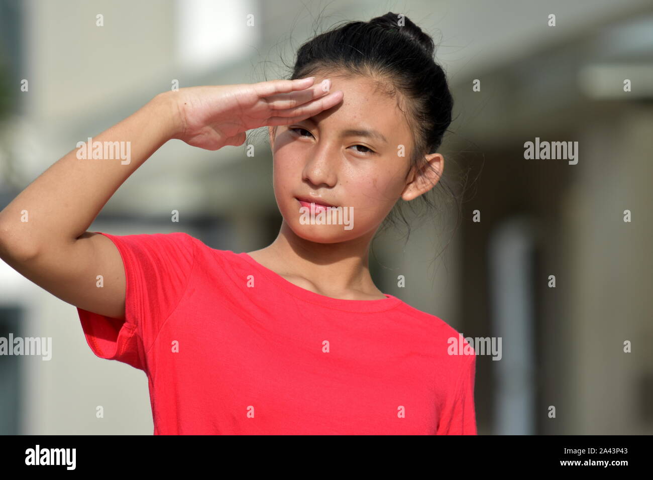 Youthful Diverse Girl Saluting Stock Photo - Alamy