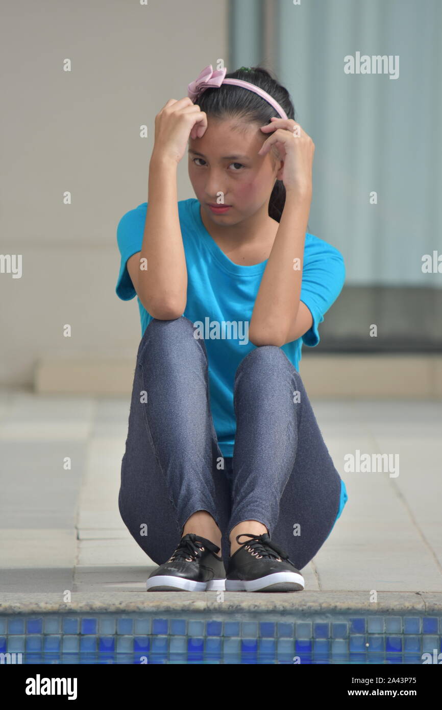 Cute Diverse Female And Sadness Sitting By Pool Stock Photo - Alamy