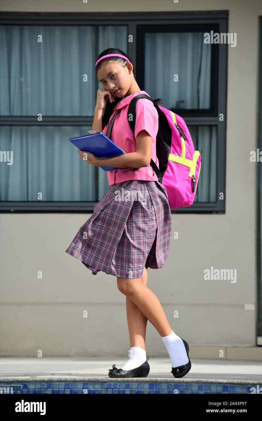 Unemotional Girl Student With Books Standing Stock Photo - Alamy