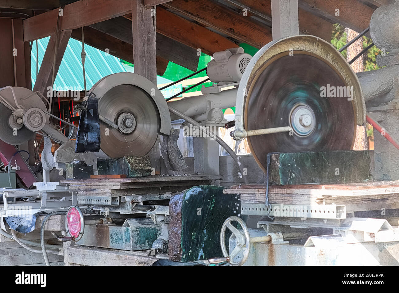 Large cutting blades cut through blocks of stone Stock Photo - Alamy