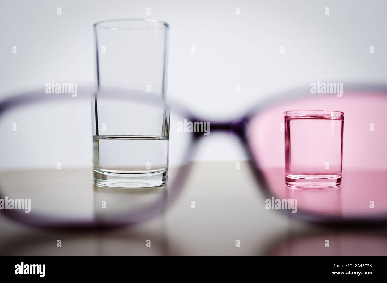 Optimism, illustrated by comparing less than half full glass in one ...