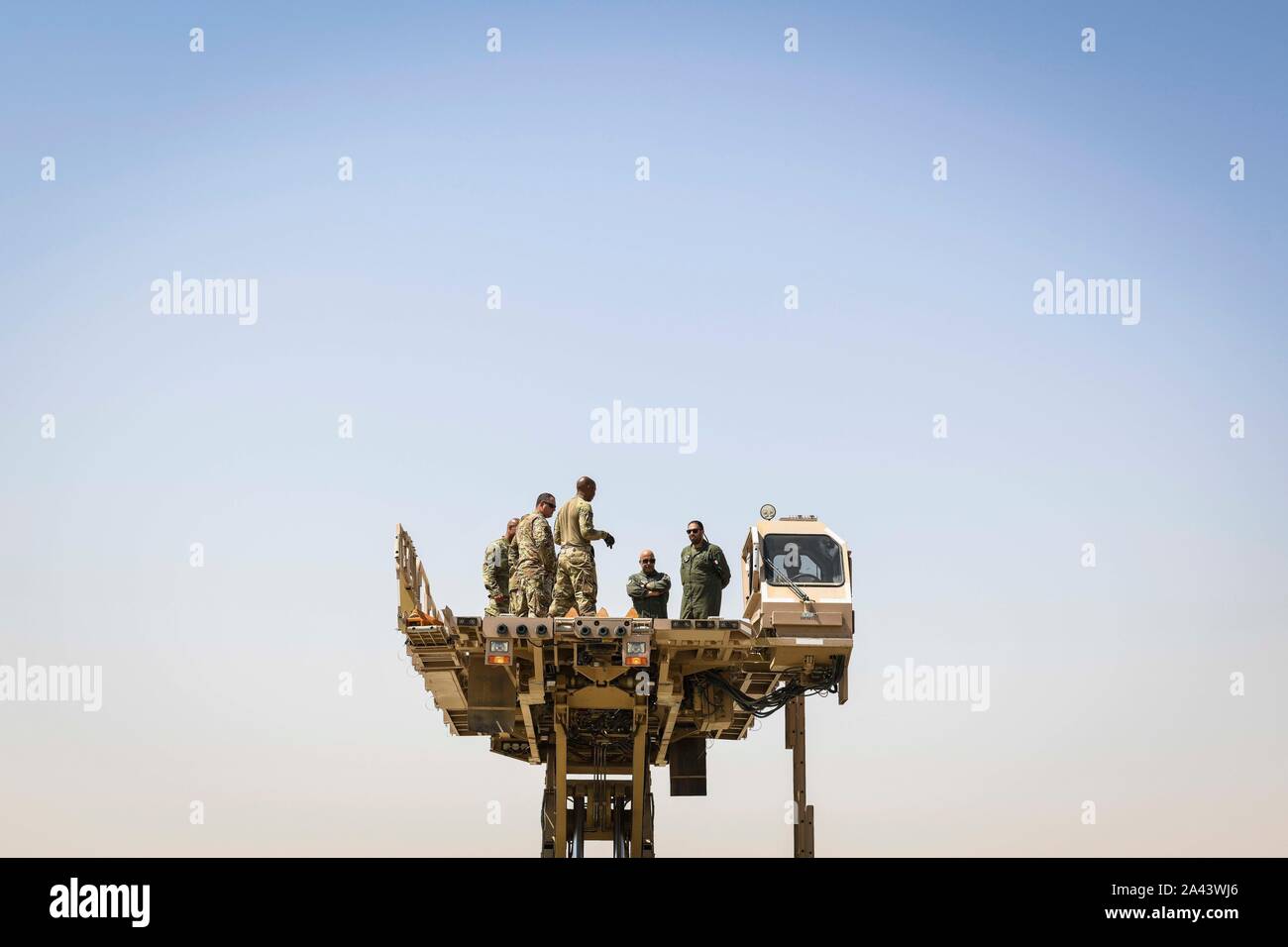 U.S. Air Force service members give a tour of their work area to ...
