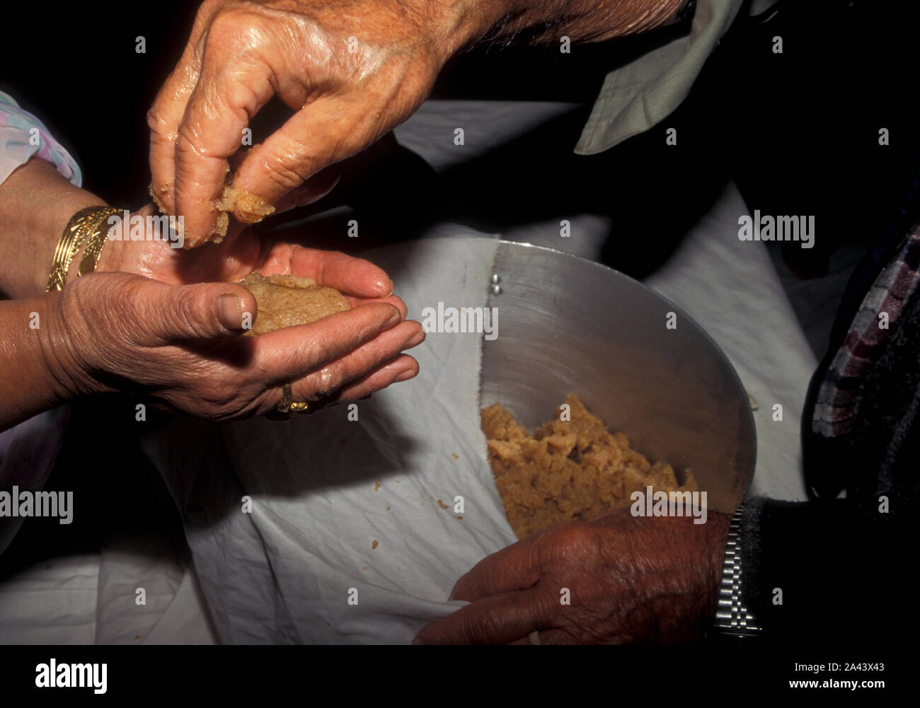A women receives Karah Prashad, a ritual during Sikh worship in the ...