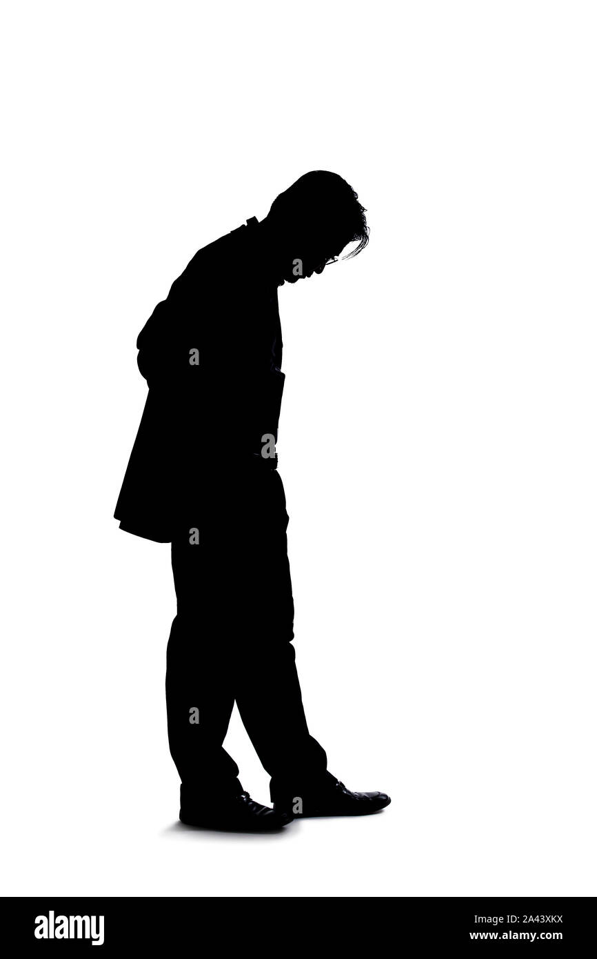 Full body silhouette of a businessman isolated on a white background. He is standing and waiting ...