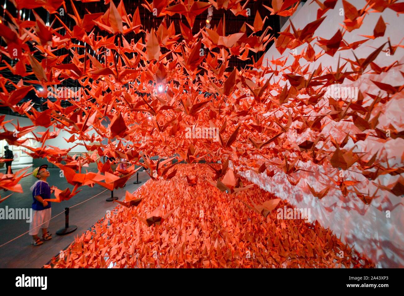 Visitors enjoy art works displayed at The Splendid Languages of Paper ...