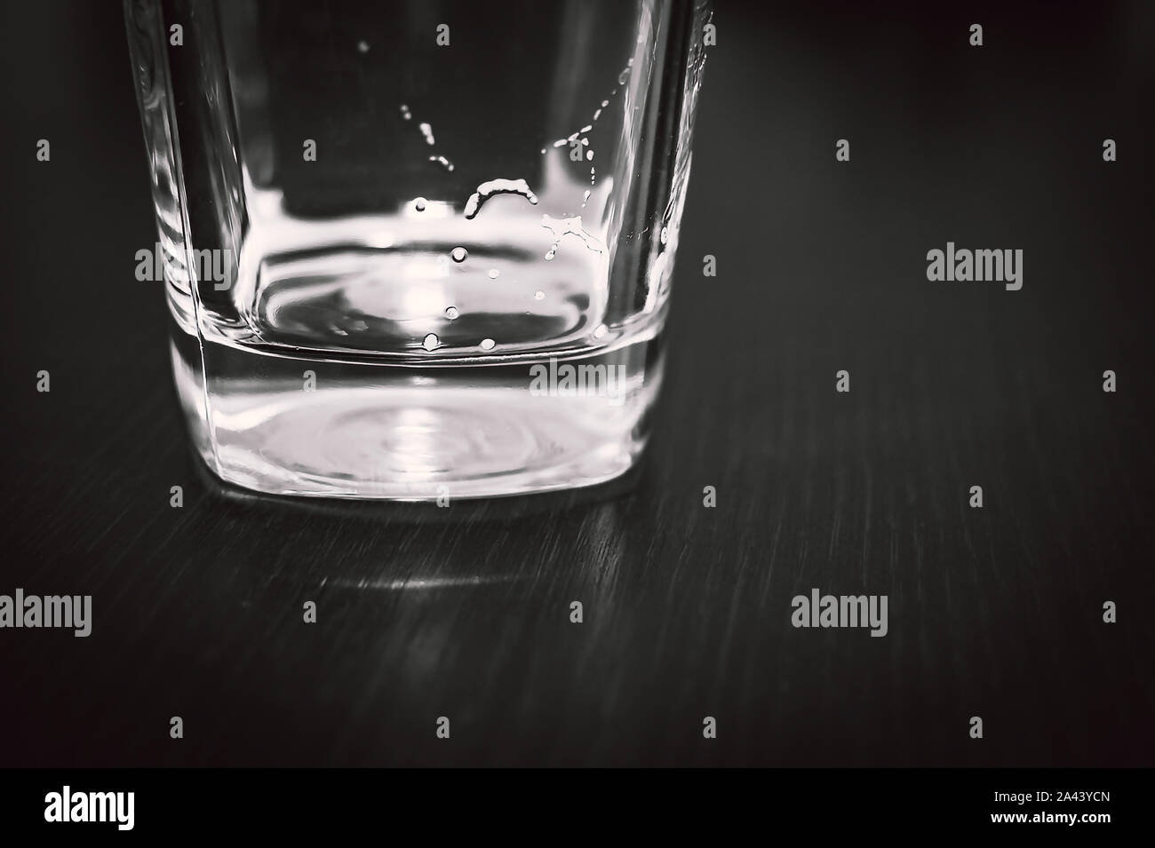 Square Bottom of Empty Beer Glass on Dark Table Surface. Bubbles Left ...