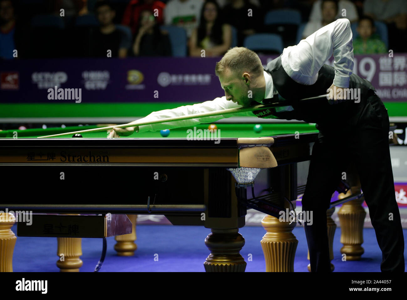 Judd Trump of England plays a shot to Tom Ford of England in their ...