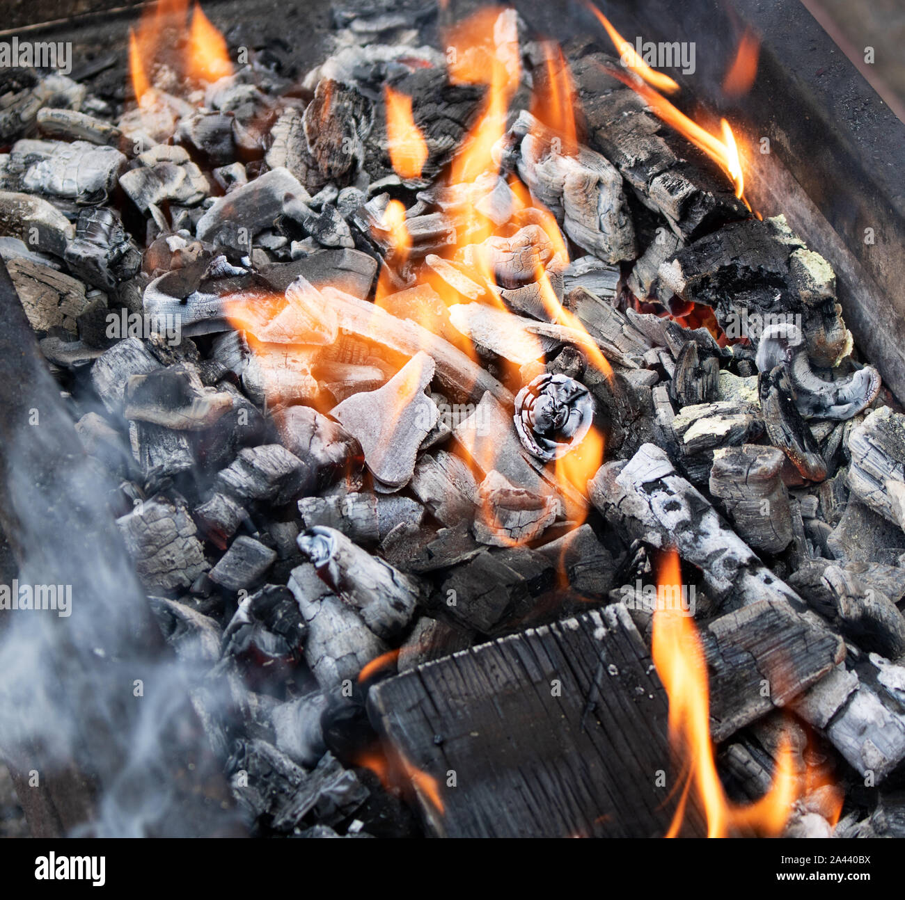 dry sticks burn in the fire to make hot coals,vertical Stock Photo - Alamy