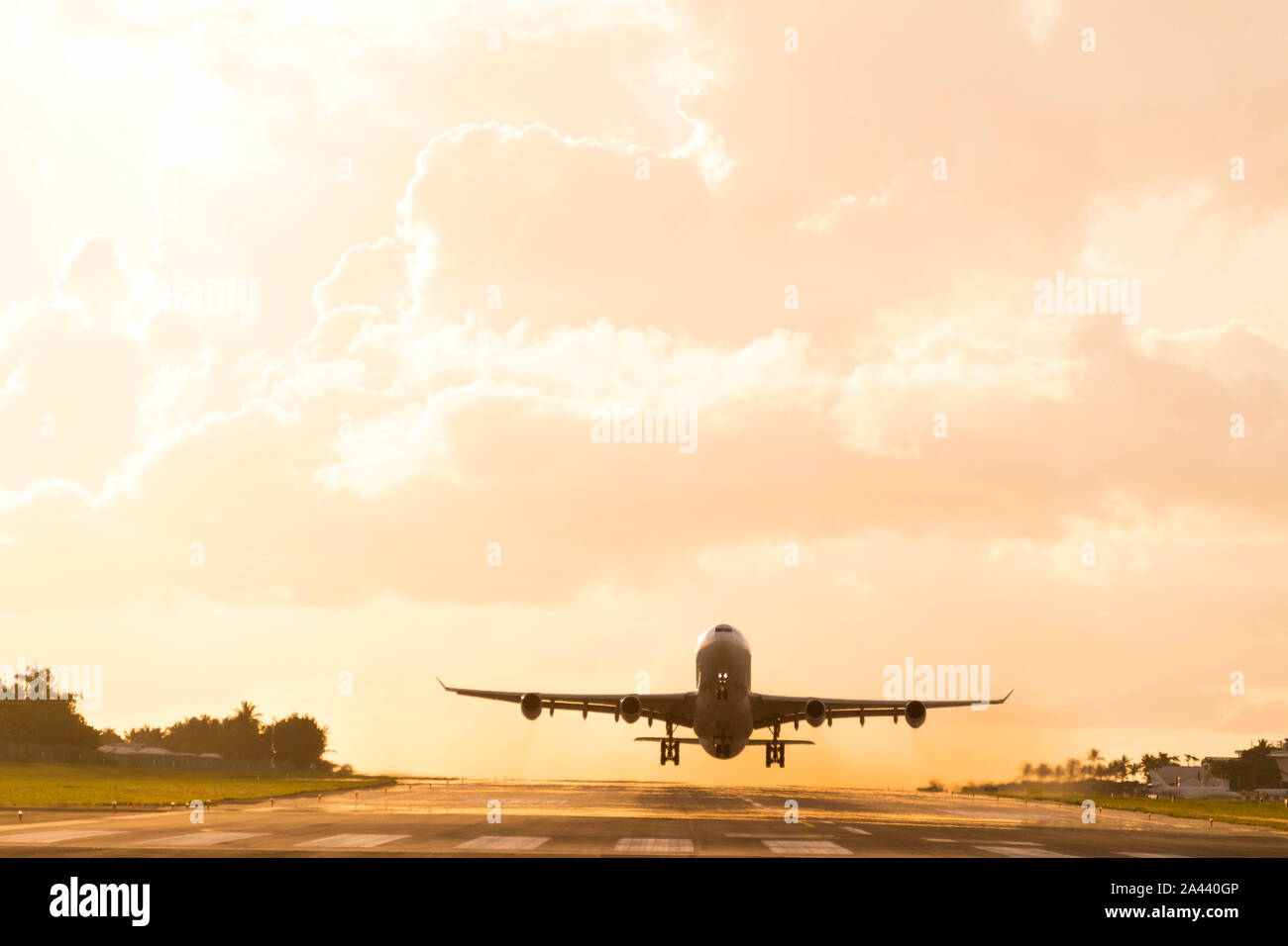 Plane taking off during sunset on st.maarten Stock Photo - Alamy