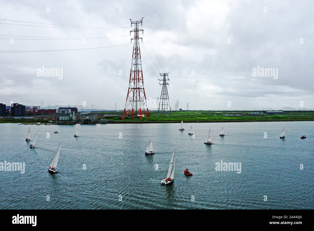 Sailboats compete against each other despite the cloudy weather in ...