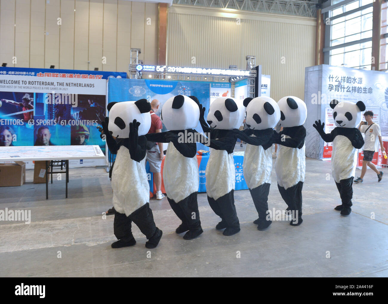Chinese workers dressed in giant panda costumes pose during the 2019 ...