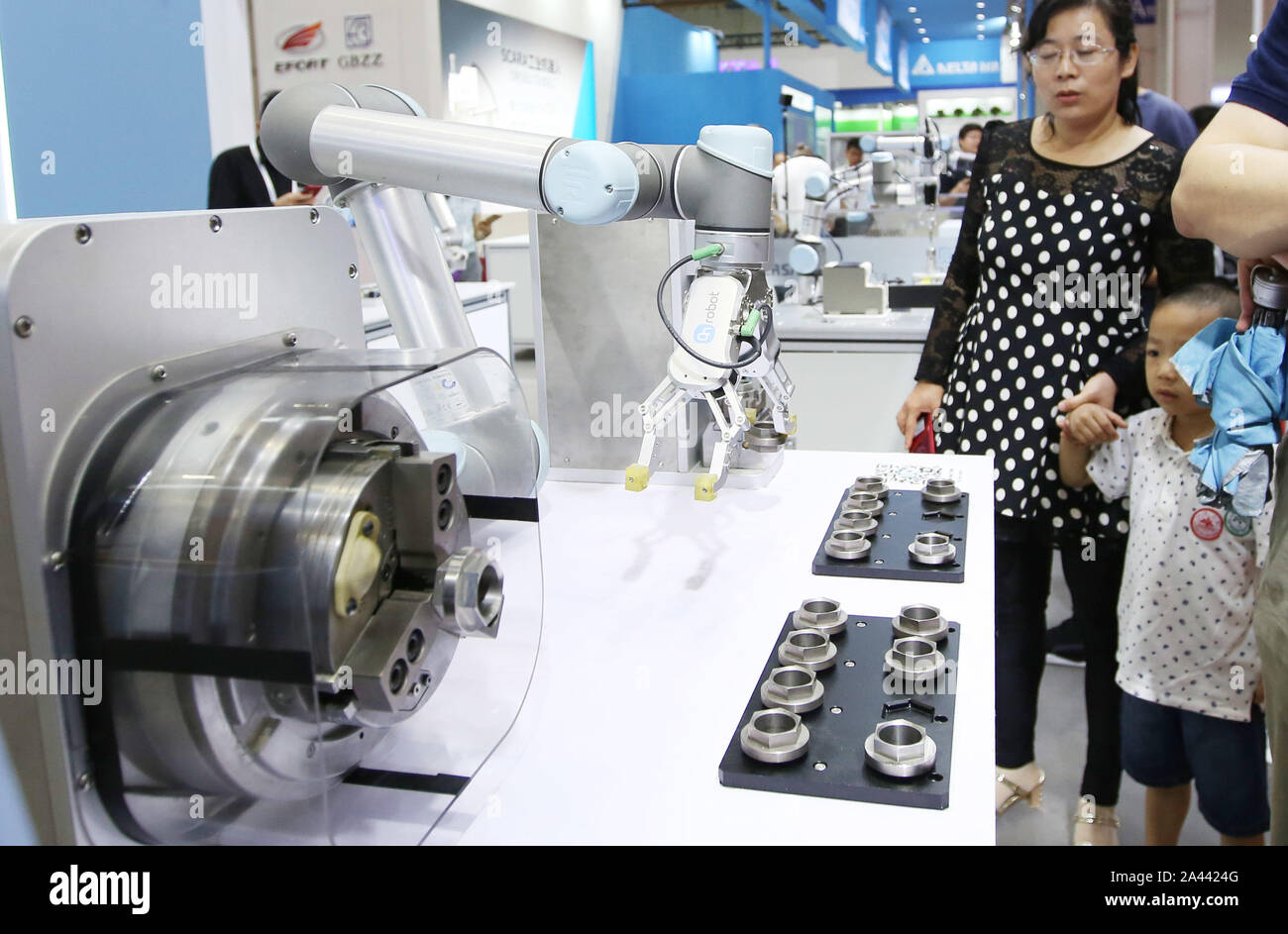 Visitors observe the parts of robots at the 2019 World Forum on Robot ...