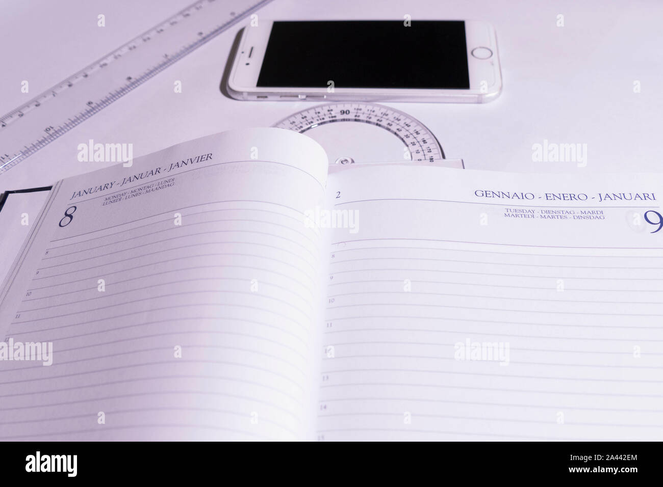 Open agenda next to a phone and rulers Stock Photo - Alamy