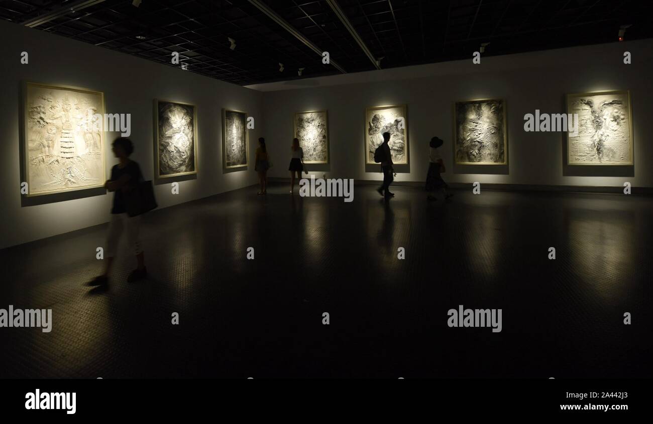 Visitors enjoy art works displayed at The Splendid Languages of Paper ...