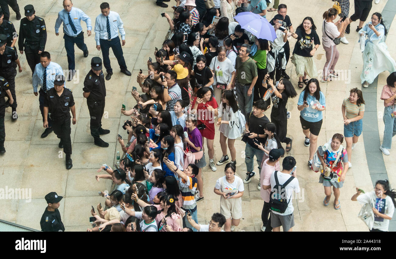 Chinese fans crowd a shopping mall to support singer and actor Karry ...