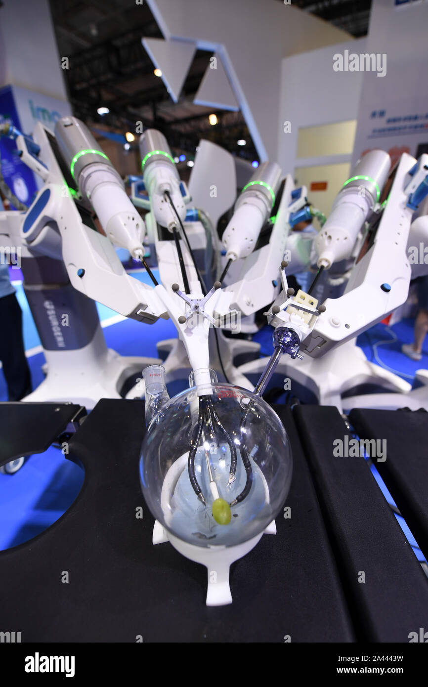 A surgical robot of laparoscopy puts sutures on a grape during the 2019 ...