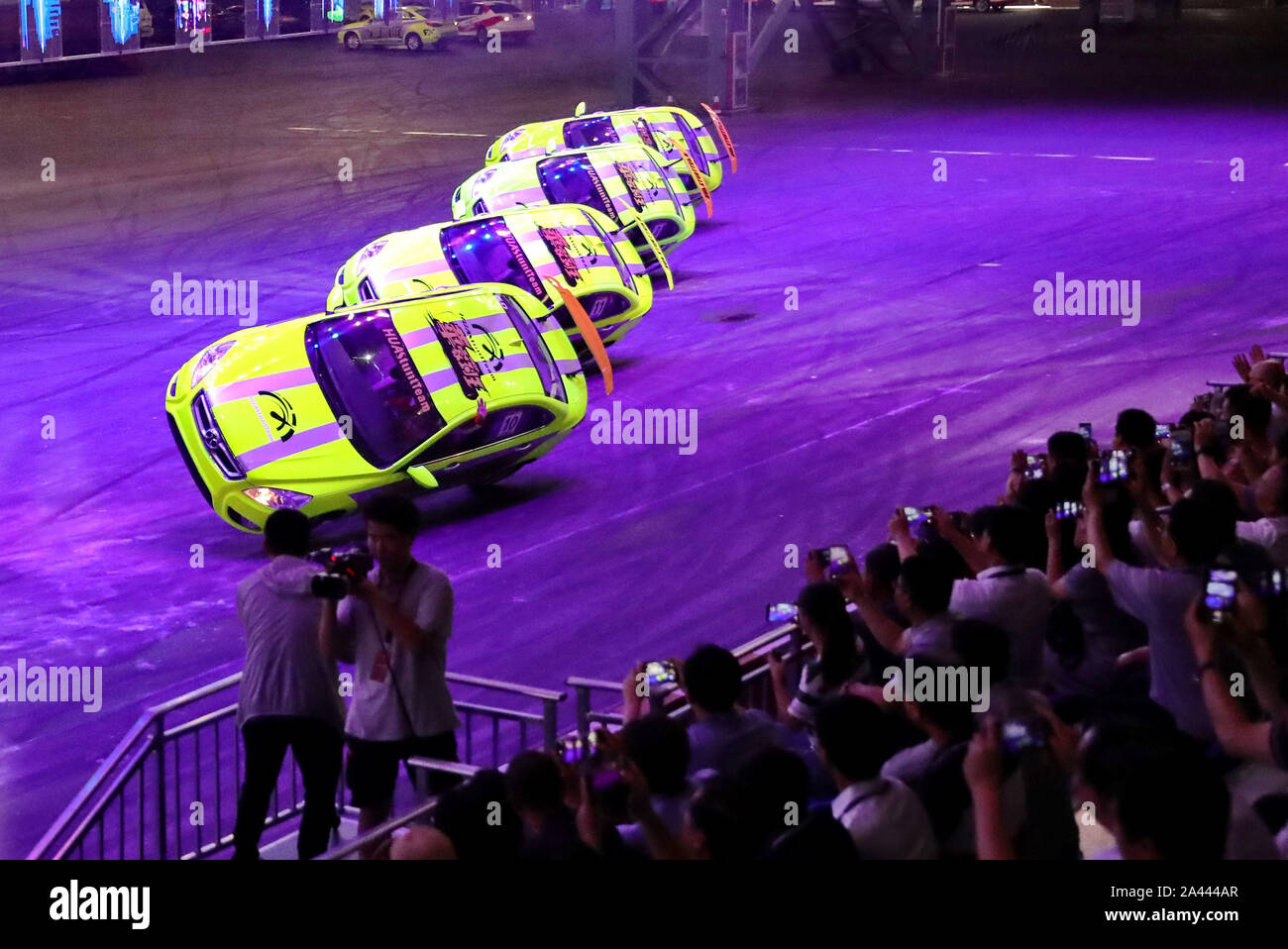 Members of car racing acrobatic teams perform during the reopening ...