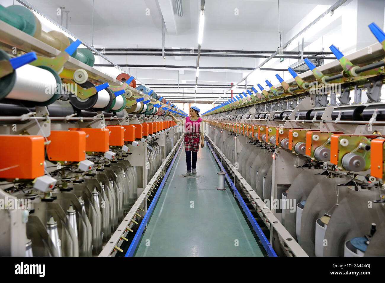 --FILE--A female Chinese worker handles production of yarn at a textile factory in Hai'an city ...