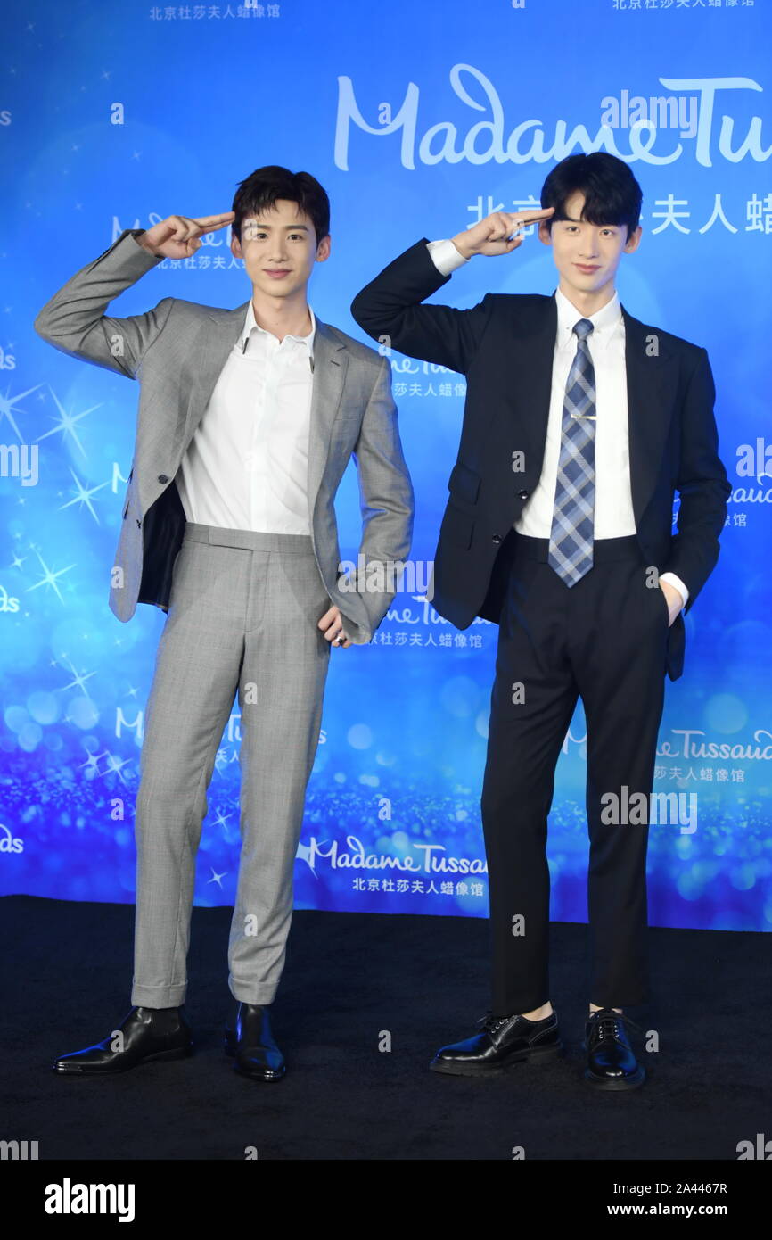 Chinese actor Bai Jingting, left, poses with a wax figure of him during ...