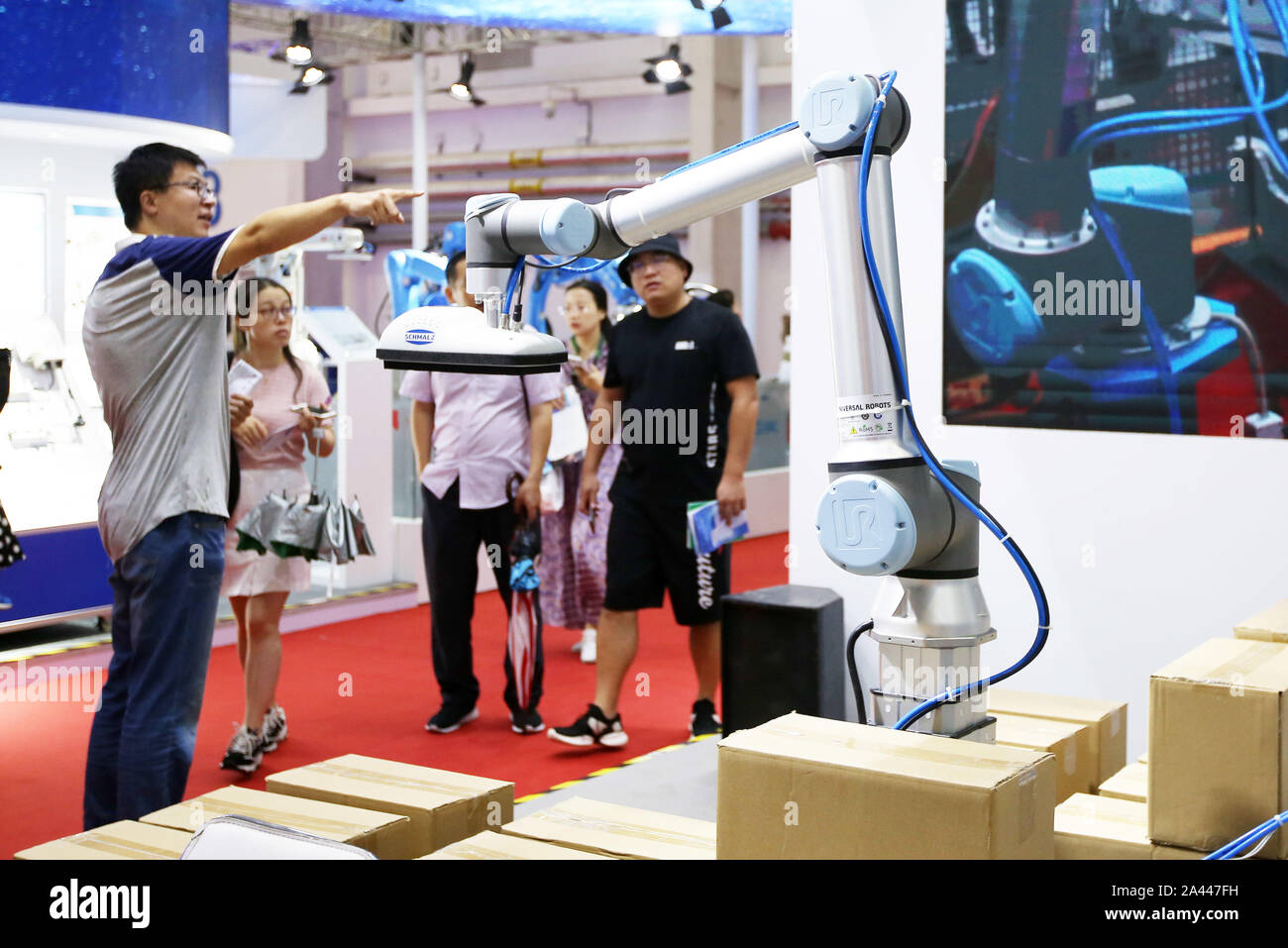 Visitors observe the parts of robots at the 2019 World Forum on Robot ...