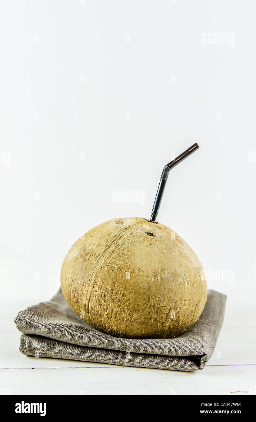 coconut with a tube on a white background. copy space Stock Photo - Alamy