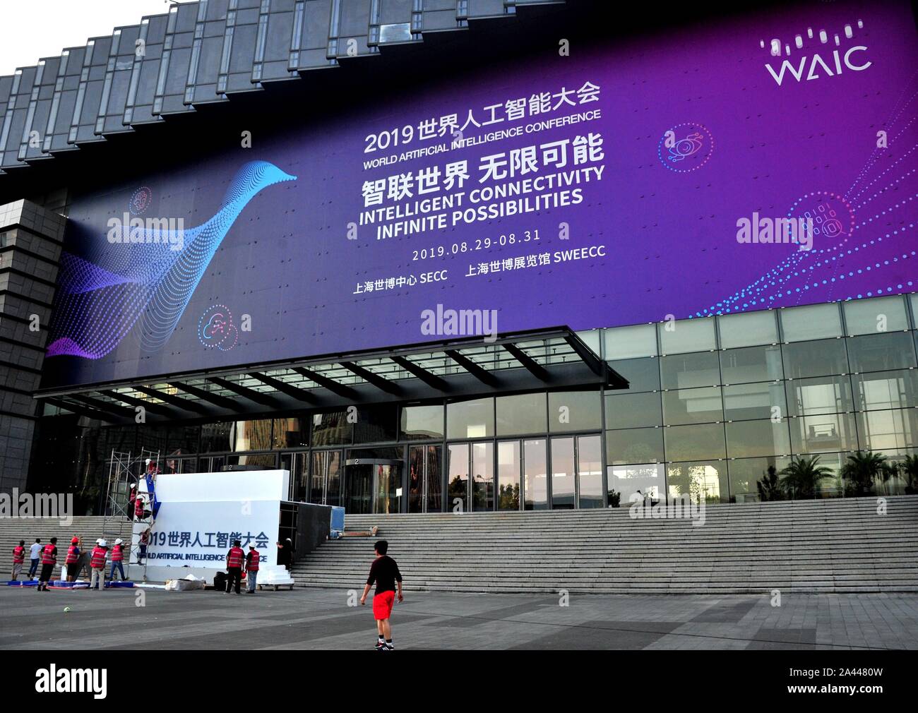 Chinese workers prepare for 2019 World Artificial Intelligence Conference (WAIC) at the Shanghai ...