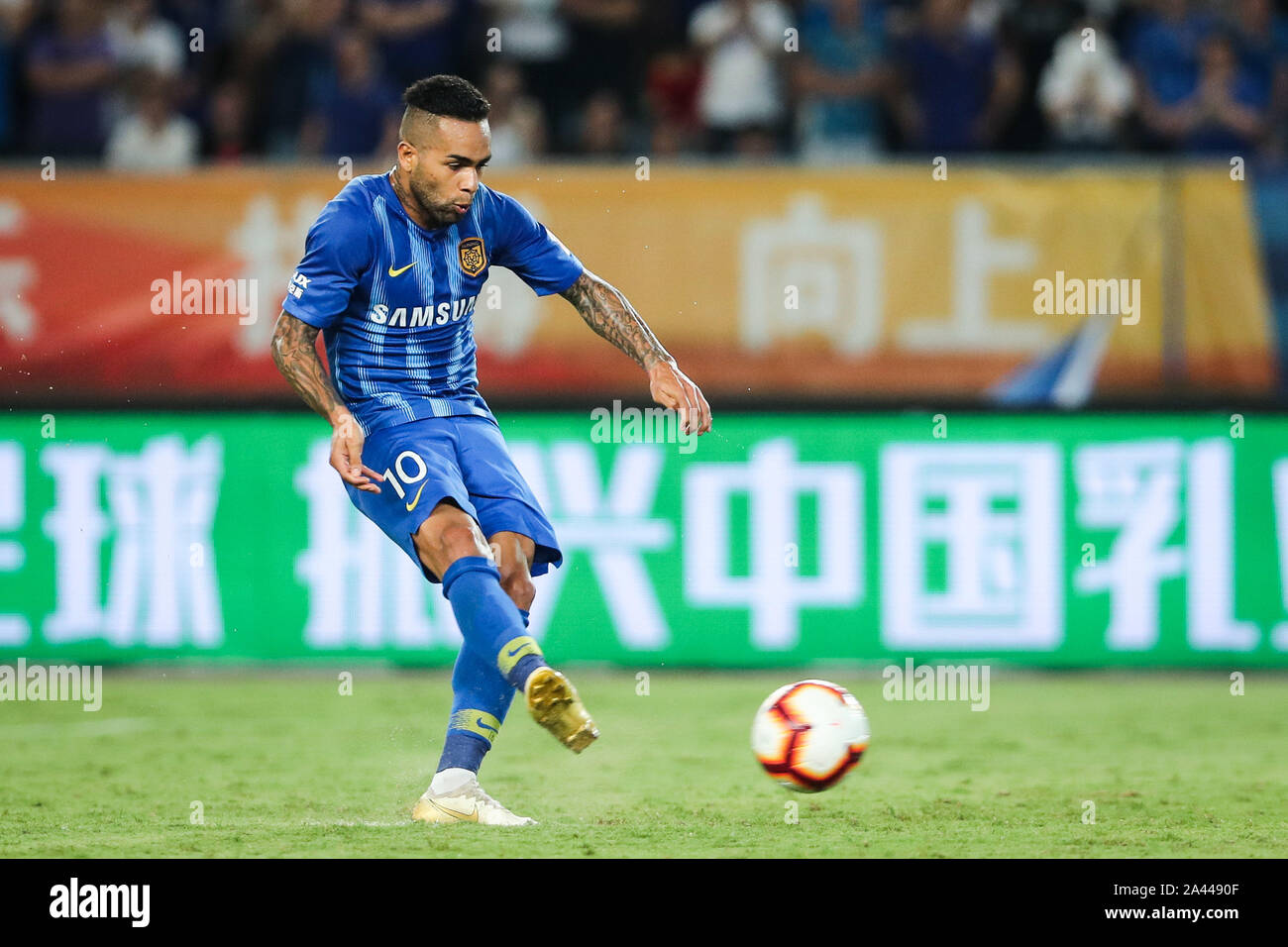 Brazilian football player Alex Teixeira of Jiangsu Suning shots the ...