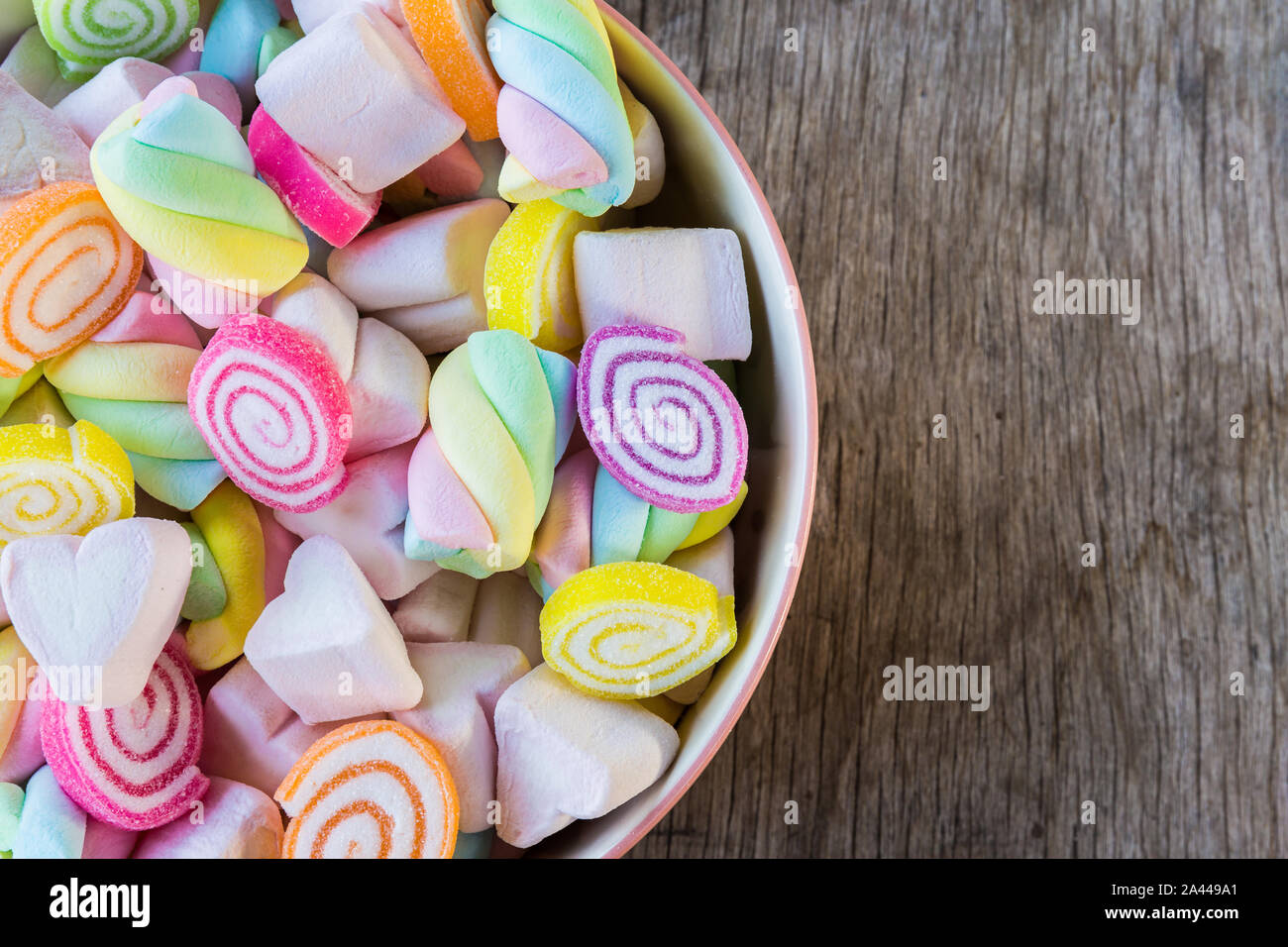 Pastel and colorfu of marshmallow and gummy candy in a wooden bowl on ...