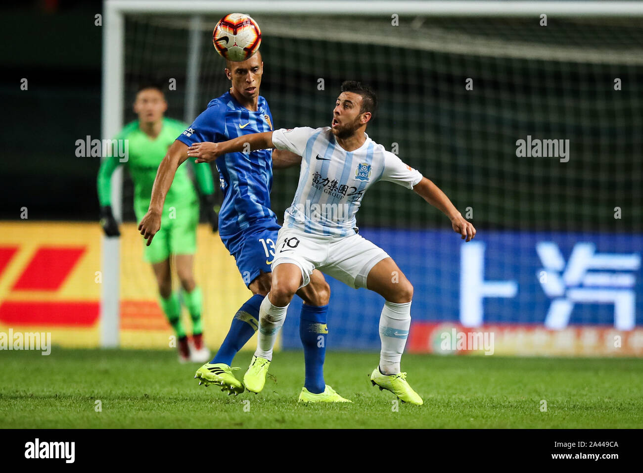 Israeli-Arab football player Dia Saba, right, of Guangzhou R&F passes ...